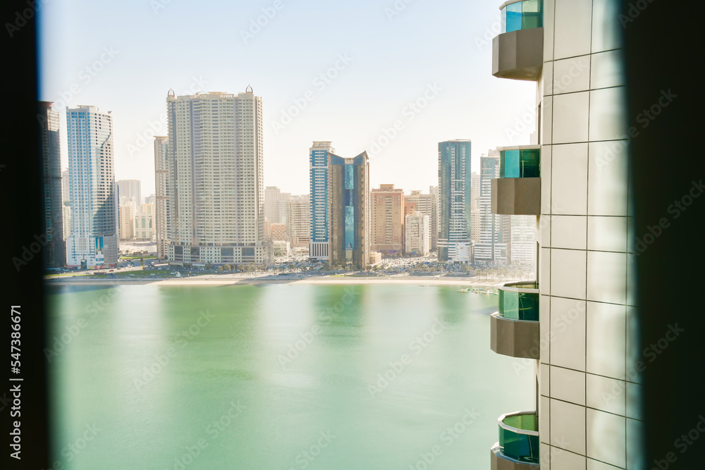 Panoramic window view to high buildings with balconies and marina in ...