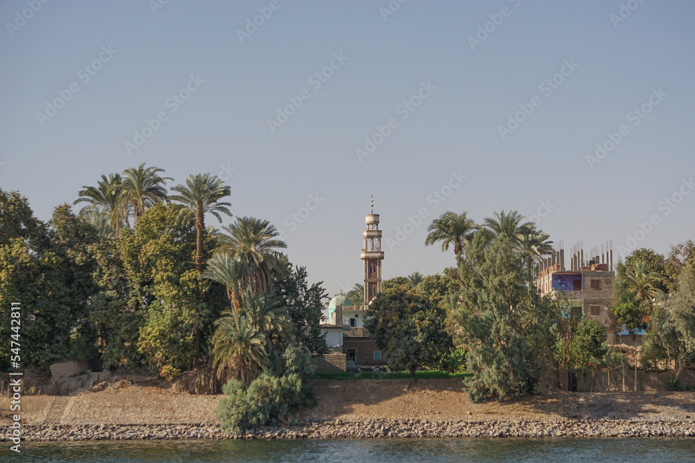 Nile River, Egypt: A minaret and houses on the east bank of the Nile ...