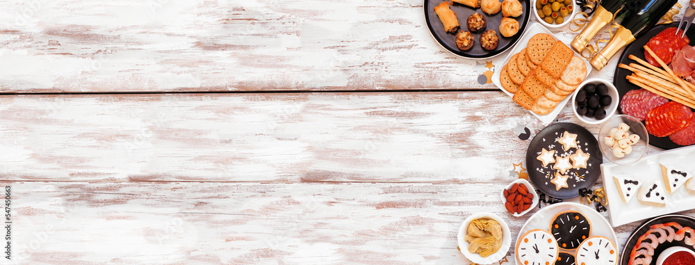 New Years Eve theme appetizer side border. Above view on a white wood ...