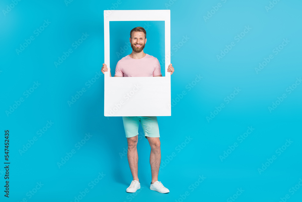 Full length photo of nice young man hold social media post photo frame ...