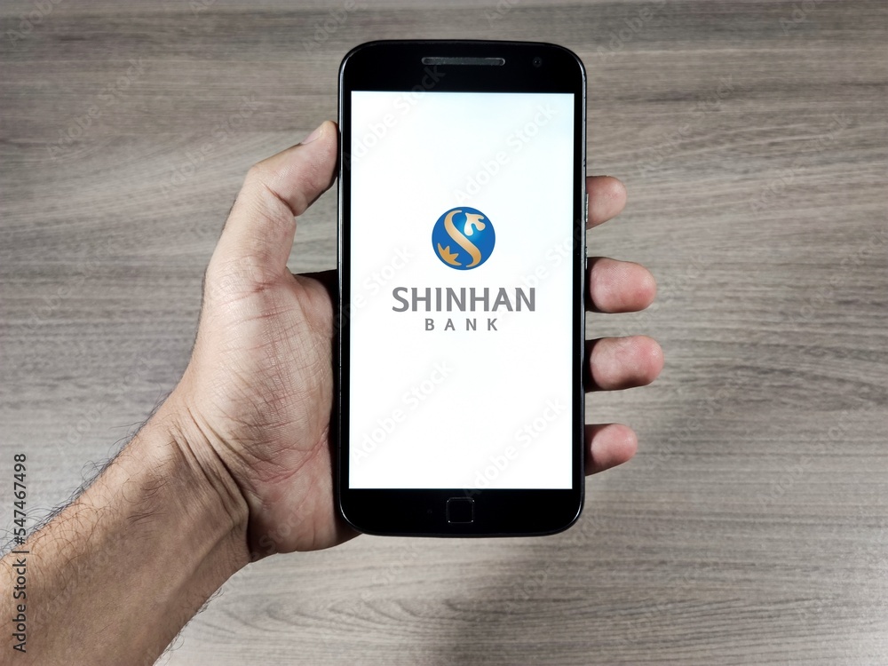 Smartphone displaying logo of Shinhan Bank, a bank headquartered in ...