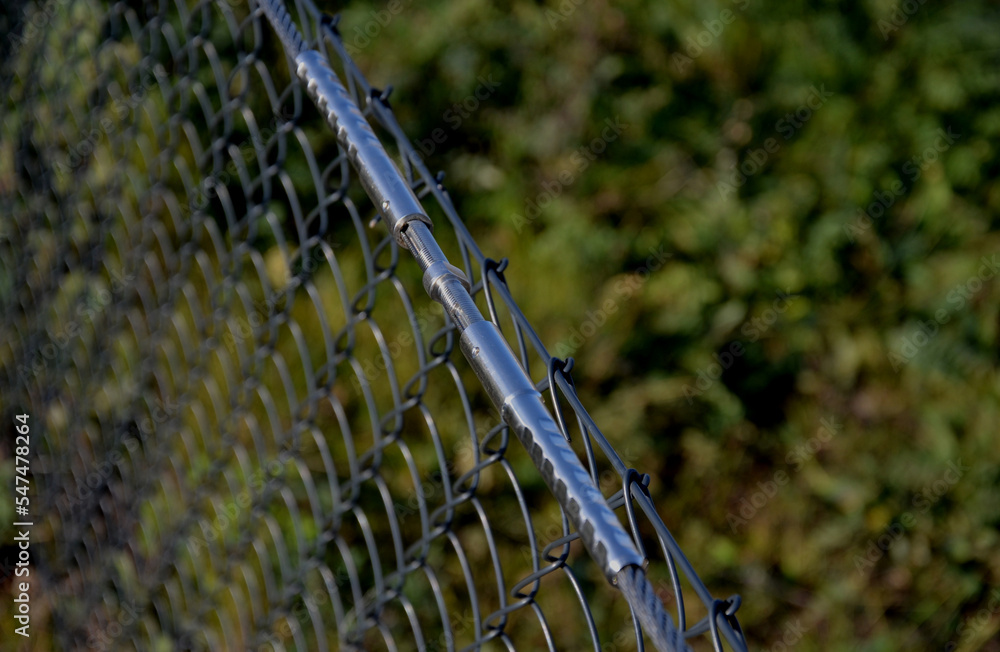 wire mesh fencing with a stainless steel guide wire and a tensioning ...