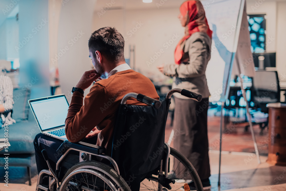 An older Muslim businesswoman presents a project to a young diverse ...