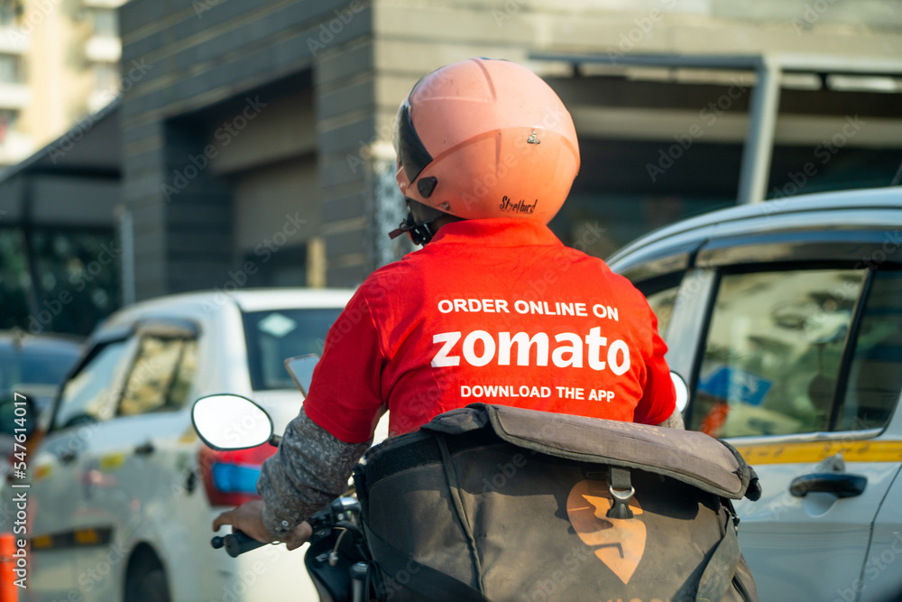 bike rider delivery boy with hot box branded with zomato the food tech ...