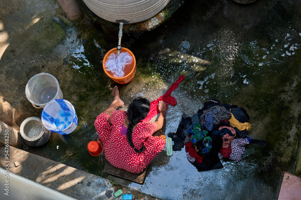 Poster Rural Indian woman washing cloths village – Wall Art | UkPosters