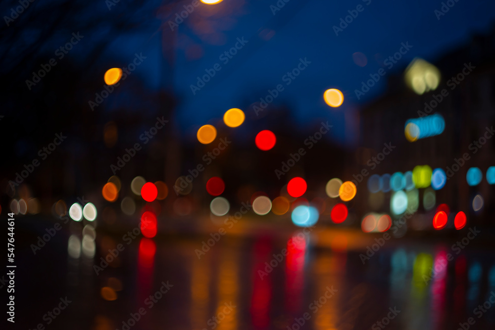 Blurred view of city street with lights at winter rainy night. Bokeh ...