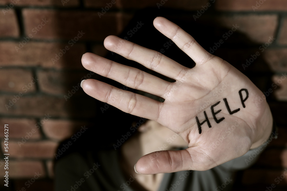 Domestic violence concept. Woman hiding her face, focus on hand with ...