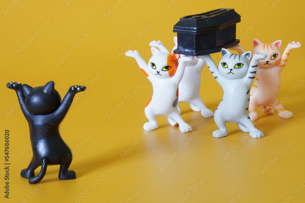 Toy funeral procession of four funny dancing kittens carrying a black ...