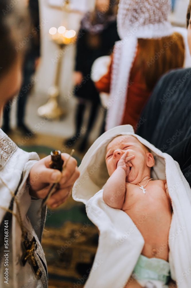 A male Christian priest in a church conducts a sacred rite, a ritual ...