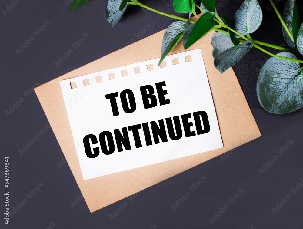 Eucalyptus leaves, an envelope and a white card with the text TO BE ...