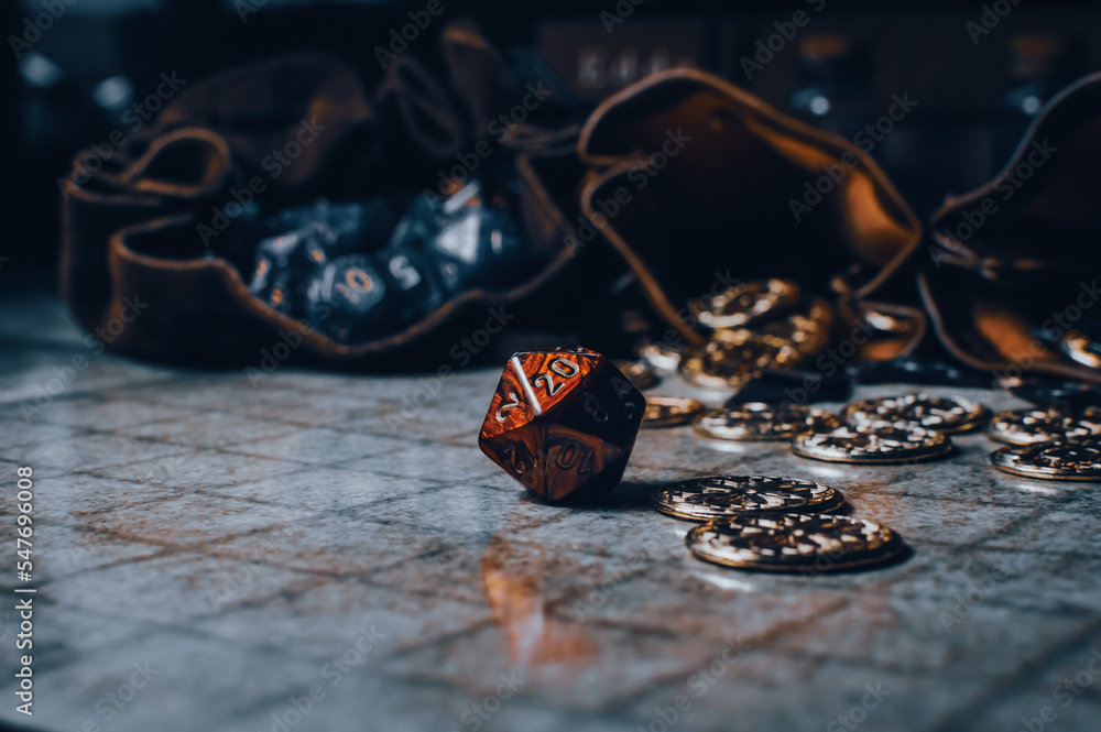Red RPG die on a gaming grid with game coins and dice bags Stock 写真 ...