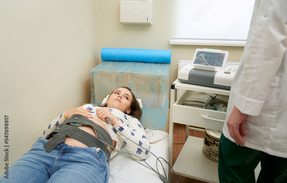 Happy pregnant female visiting her own gynecologist in medical clinic ...