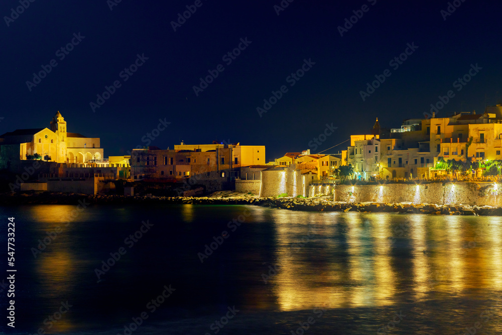 Vieste, Italy. Night view of the historic center of Marina Piccola. In ...