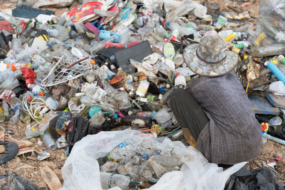 Workers hands sorting garbage for recycling.View of garbage field in ...