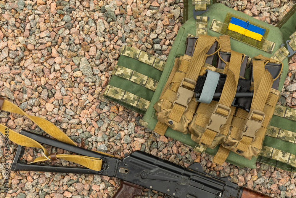 Military body armor and a Kalashnikov assault rifle. Body armor with ...