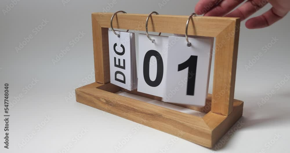 The wooden perpetual calendar with hanging papers with numbers and ...