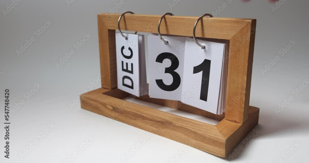 The wooden perpetual calendar with hanging papers with numbers and ...