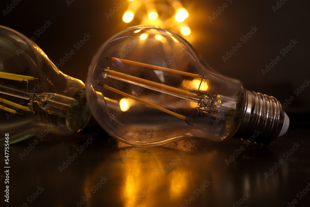 Lightbulb with candles in the background. Concept of loadshedding ...