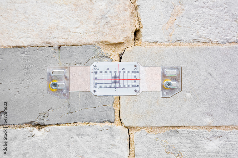 Deep crack in a damaged old stone wall cause due to subsidence of ...
