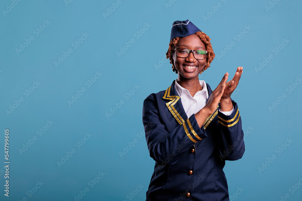 Optimistic excited female flight attendant in professional uniform ...