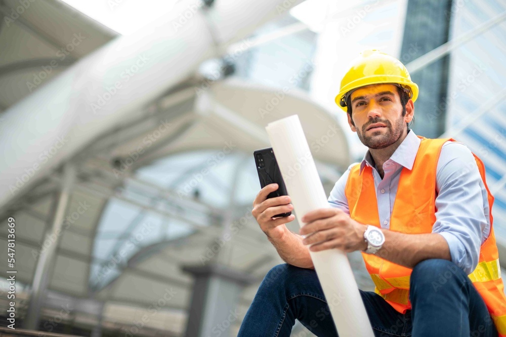 Fotografia do Stock: Caucasian man engineers use a smartphone for ...