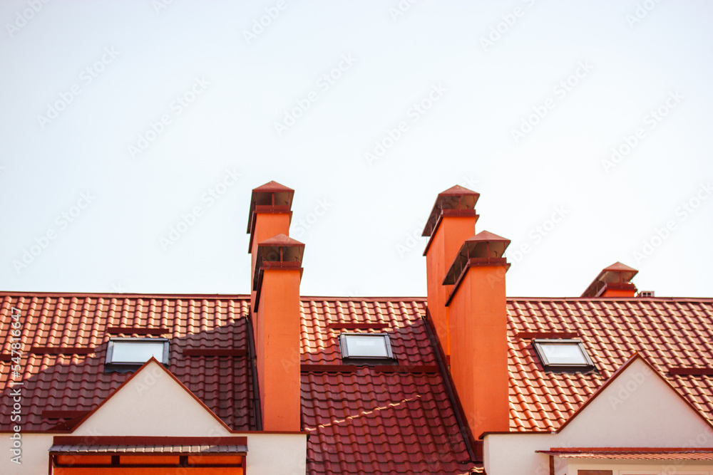 Red tiled roof, modern building with dormer windows chimneys stacks ...