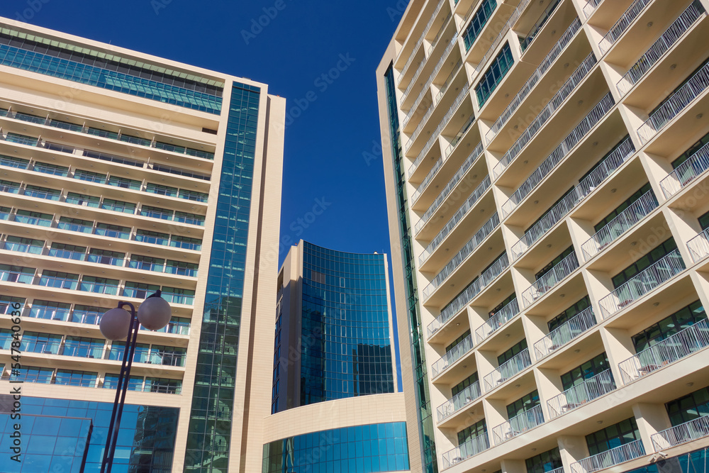 Hotel buildings against the sky. Glazing of high-rise structures of ...