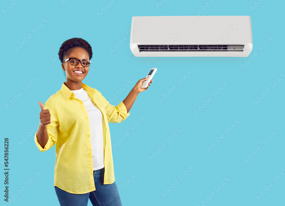 Afro American woman enjoys fresh air from AC unit. Happy smiling ...