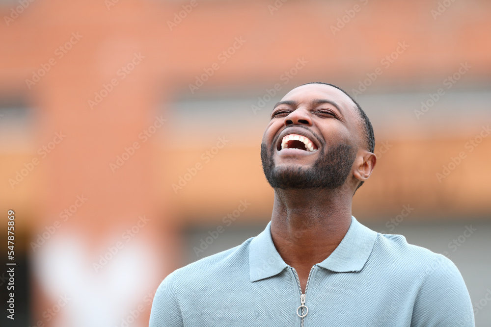 Happy black man laughing in the street Stock Photo | Adobe Stock