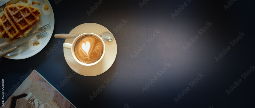 free time coffee Latte art in cappuccino coffee cup and waffle at cafe ...