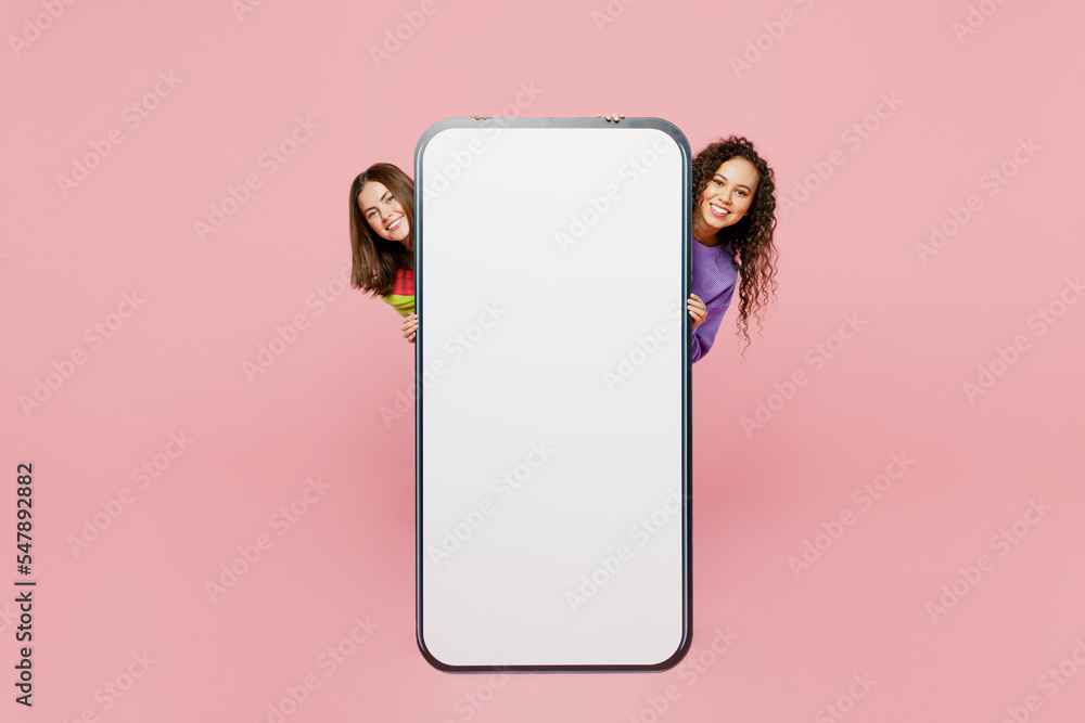 Full body young two friends smiling happy women stand behind big huge ...
