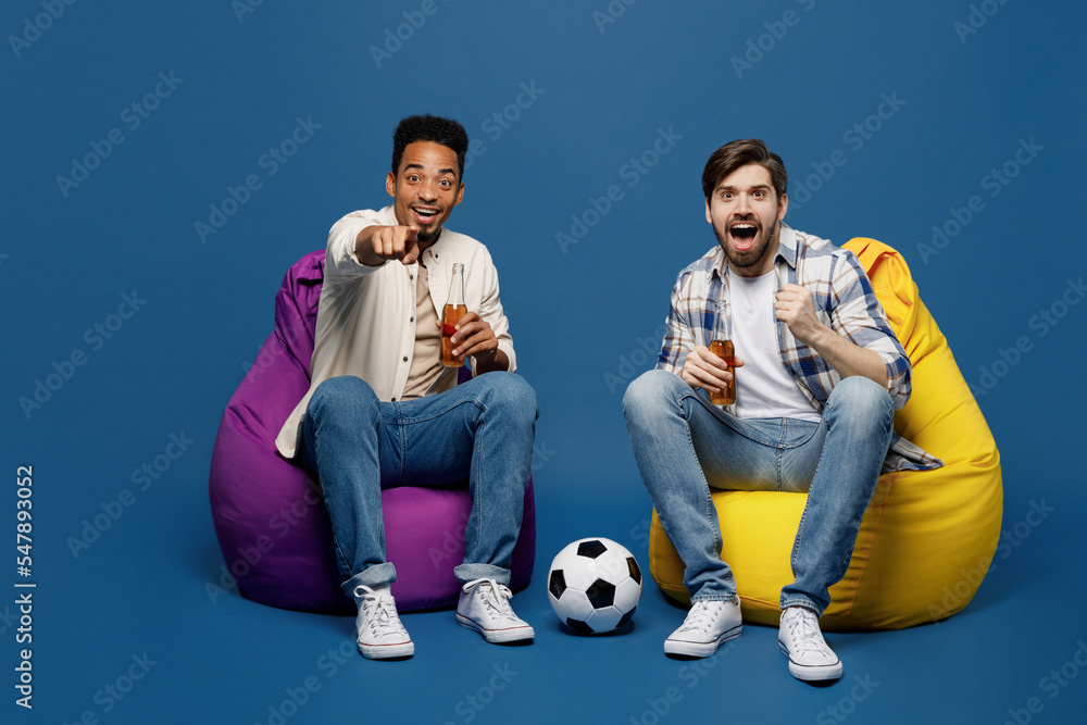 Young two fan friends men wear casual shirts together cheer up support ...