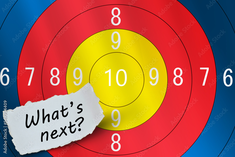 What is next word on paper with target board as background Stock ...