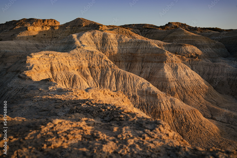Arid cliff in Valle de la Luna during golden hour, an arid desert ...