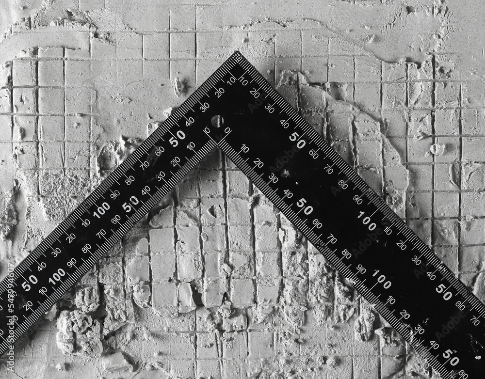 Wet cement reinforcement with wire mesh and metal engineer corner ruler ...