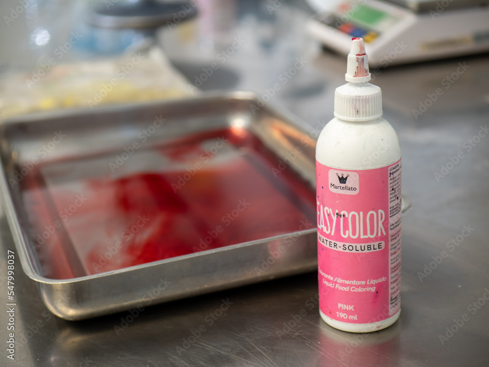 pastry chef using red color for dry rice paper sails for layer cake ...