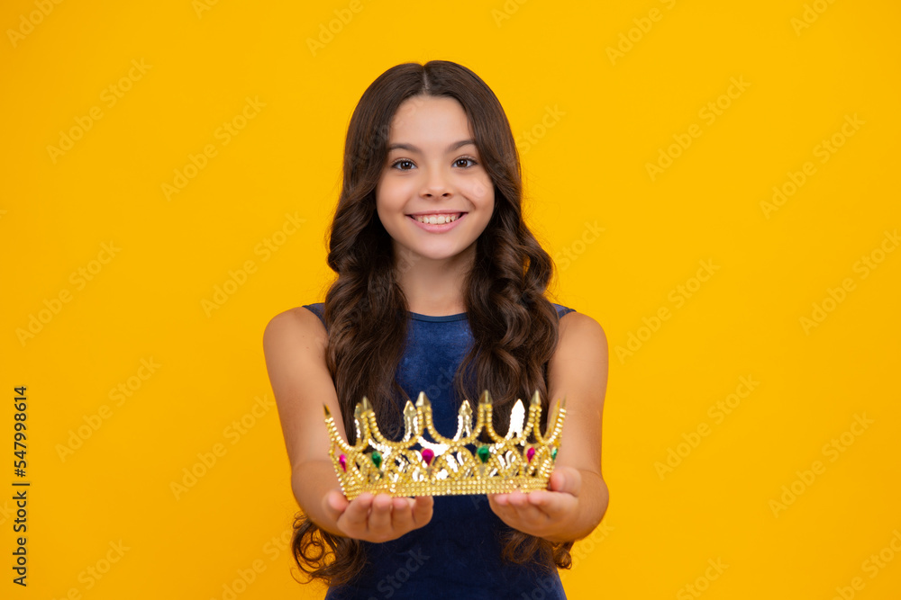 Little queen wearing golden crown. Teenage girl princess holding crown ...