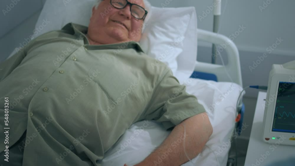 . Happy old man patient in the hospital room while resting and recover ...