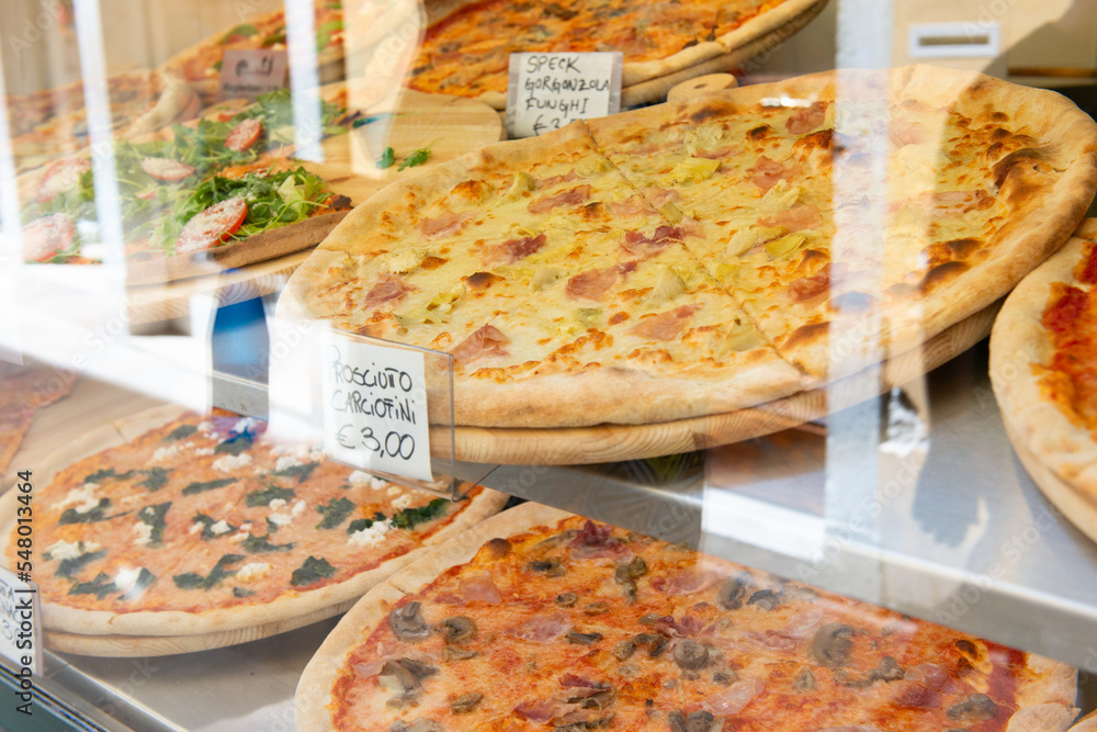 Different types of pizza are sold in a street food cafe in Italy Stock ...