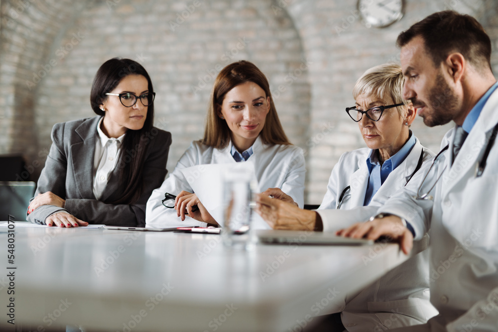 Group of doctors analyzing medical data while having a meeting in the ...