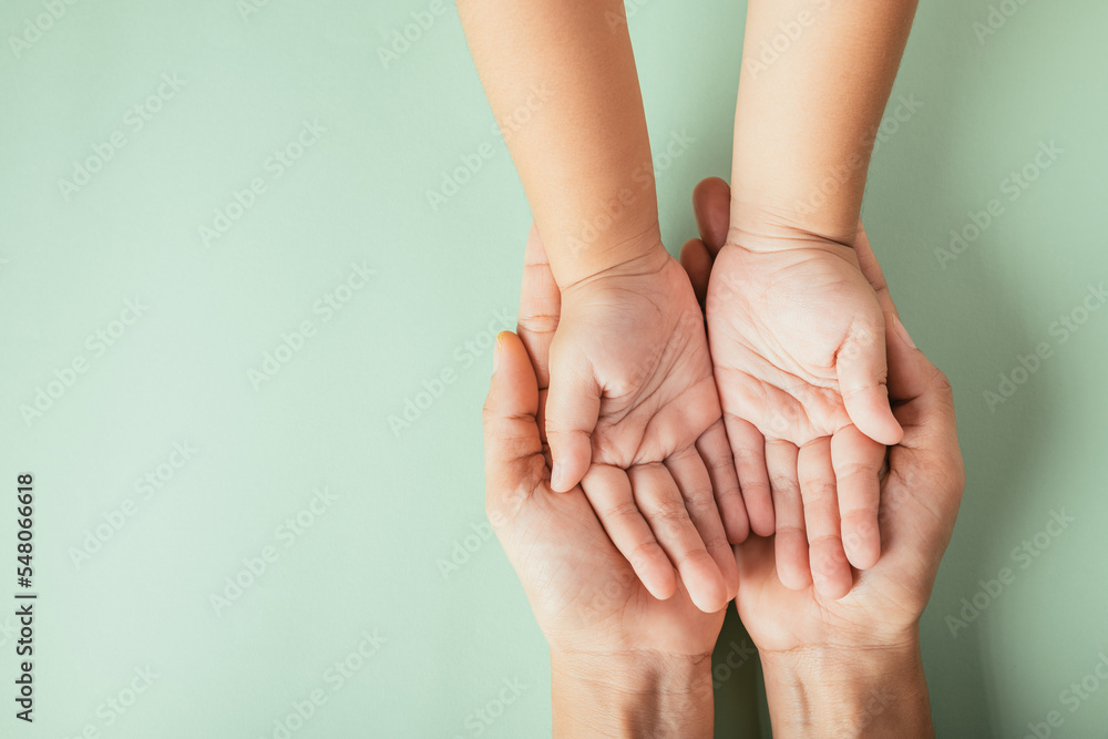 Closeup top view family hands stack palms studio shot isolated on green ...