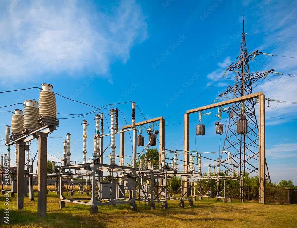 Summer. Electrical substation against the sky with clouds. In the frame ...