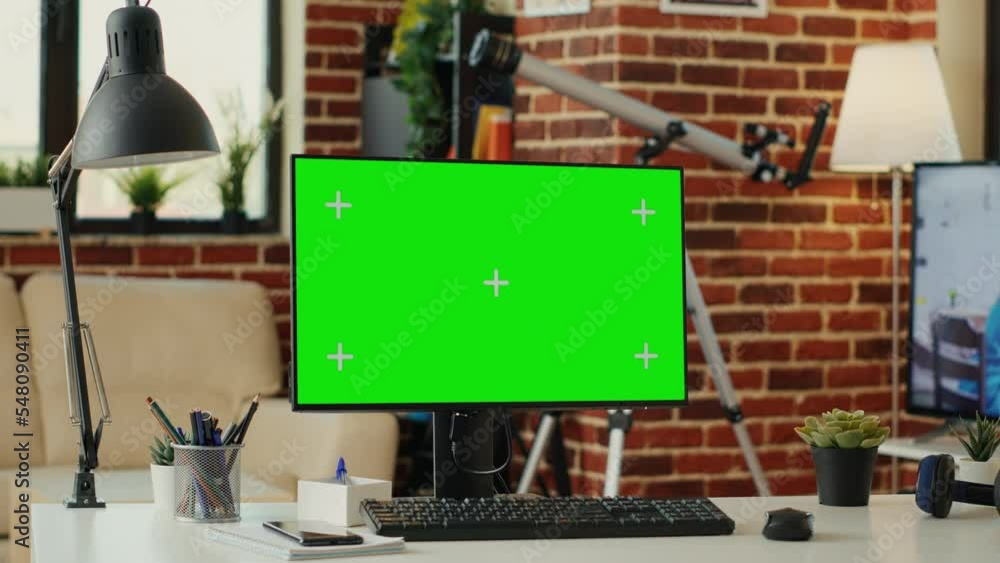 Greenscreen display on computer with empty desk in living room ...