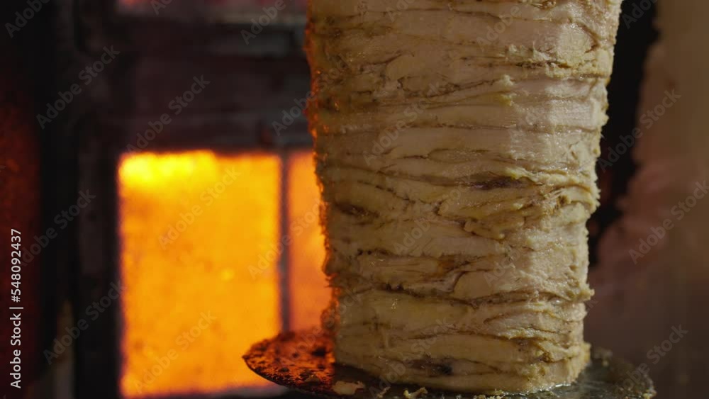 Stockvideon Shawarma meat being cut before making traditional Turkish ...
