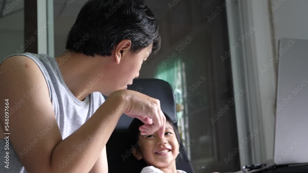 Authentic asian child boy using laptop with father. Kid typing, looking ...