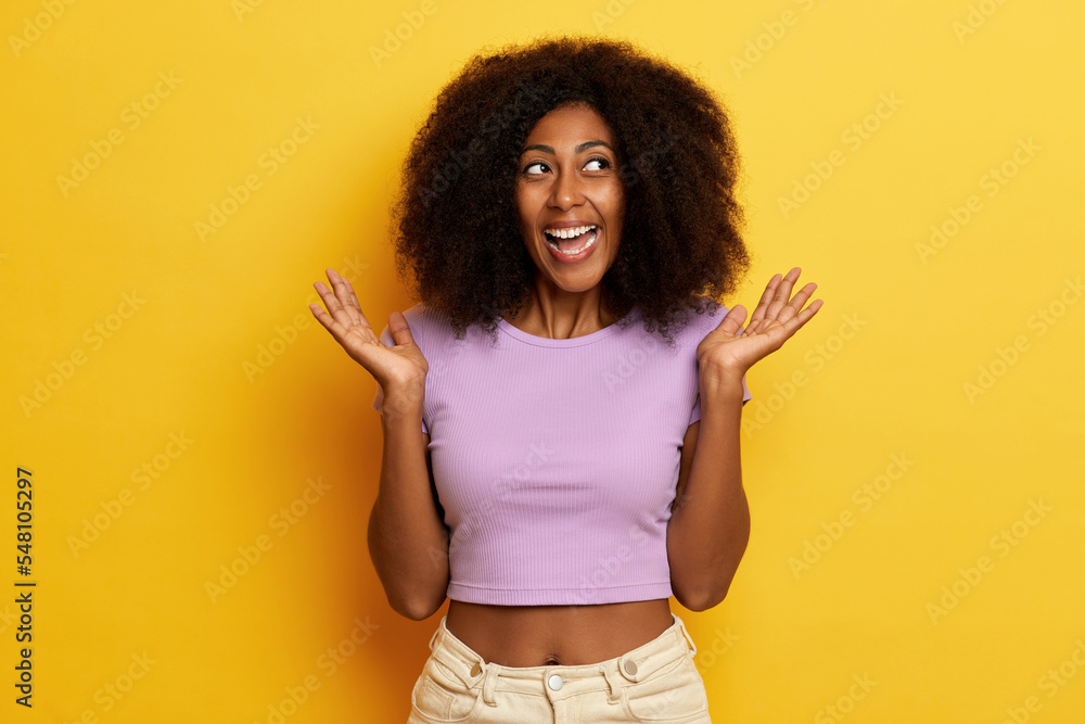Positive carefree woman with fluffy hair poses with open mouth with ...