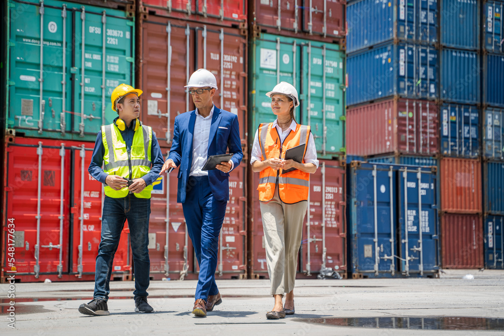 Worker and businessman checking containers data for export and import ...