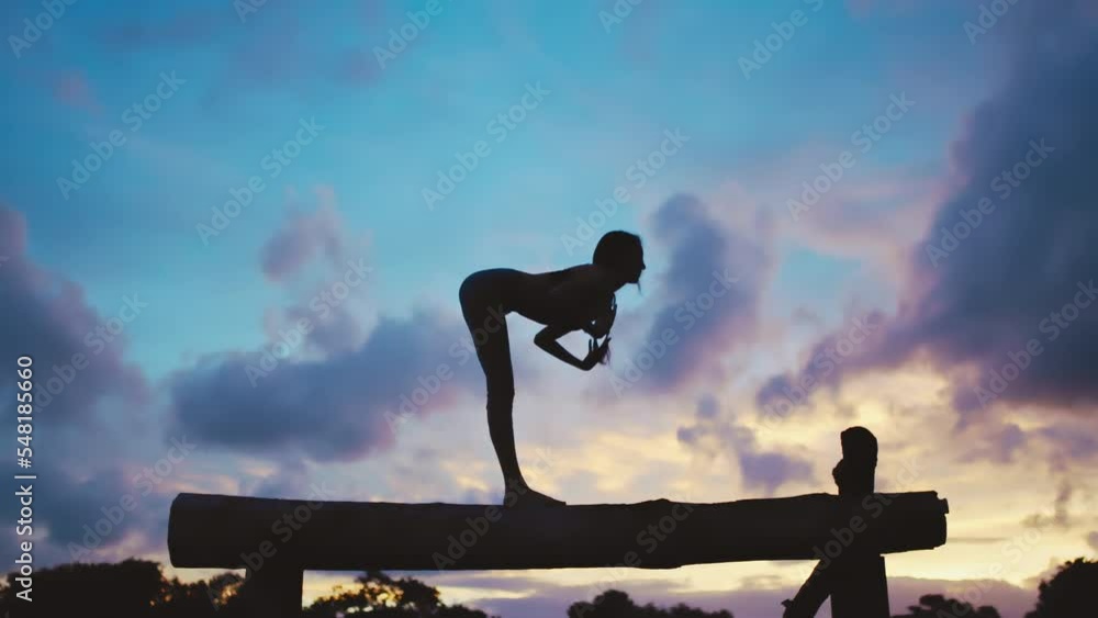 Yoga, silhouette and woman exercise against a night sky on balance beam ...