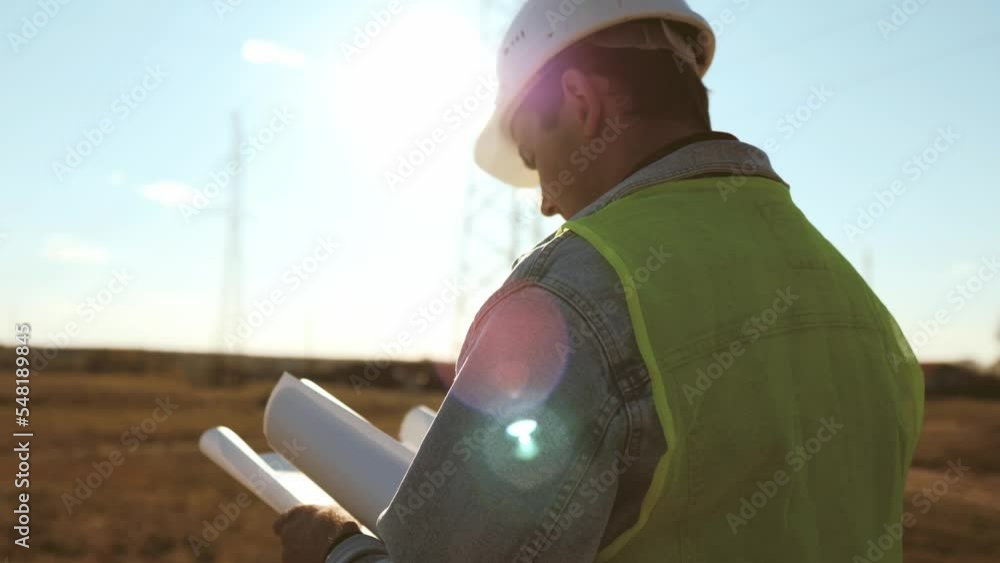 Worker male engineer using documents for checking data while standing ...