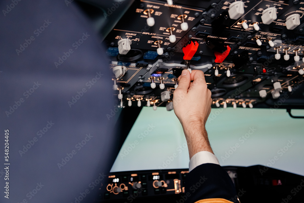 Pilot hand is controlling plane toggle switches to fly take off and ...